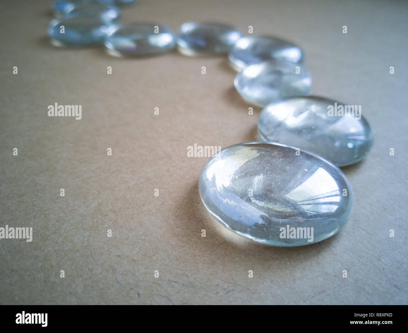 Clear marbles with light reflections on a brown background Stock Photo ...