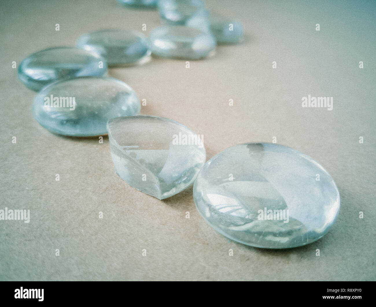 Clear marbles with light reflections on a brown background Stock Photo ...