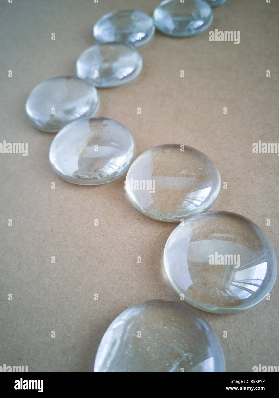 Clear marbles with light reflections on a brown background Stock Photo ...