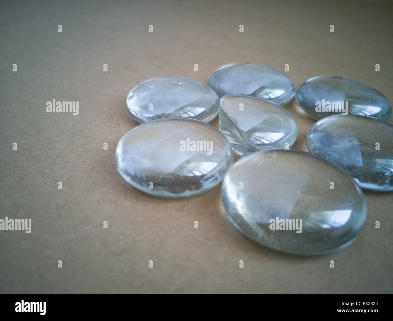 Clear marbles with light reflections on a brown background Stock Photo ...