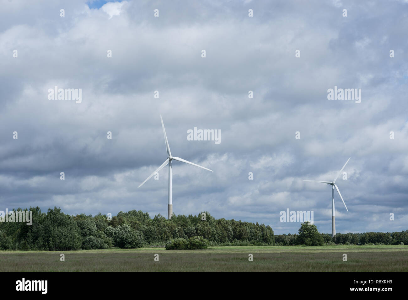 Ecology concept: Blue sky, white clouds, wind turbine and crop field ...