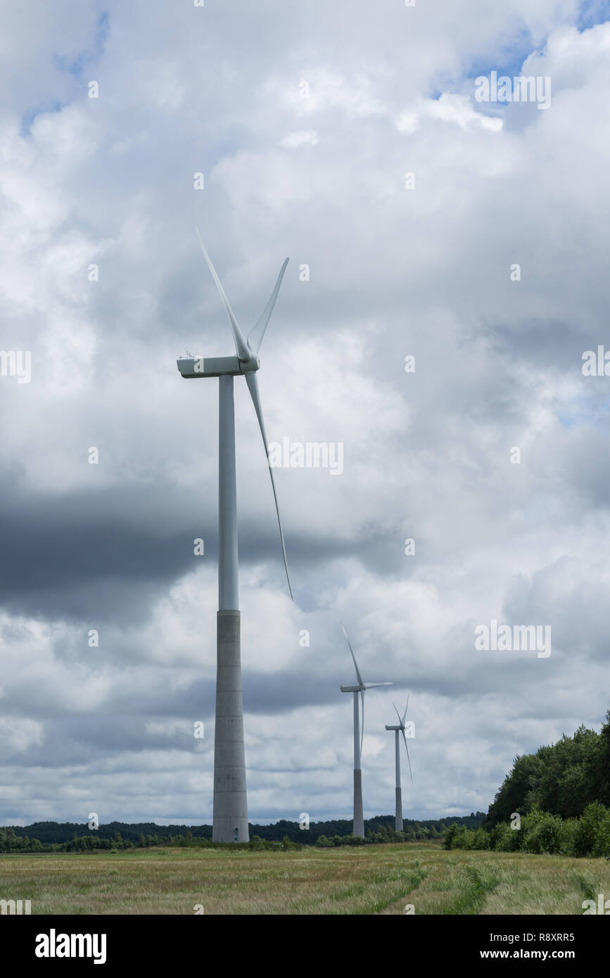 Ecology concept: Blue sky, white clouds, wind turbine and crop field ...
