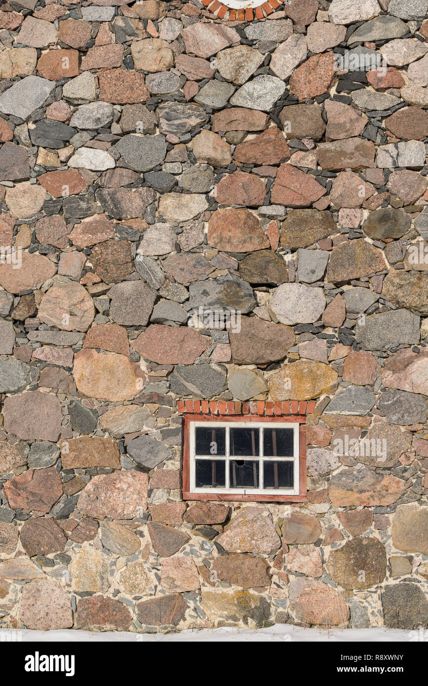 Stone wall texture and windows with red frames, natural background ...