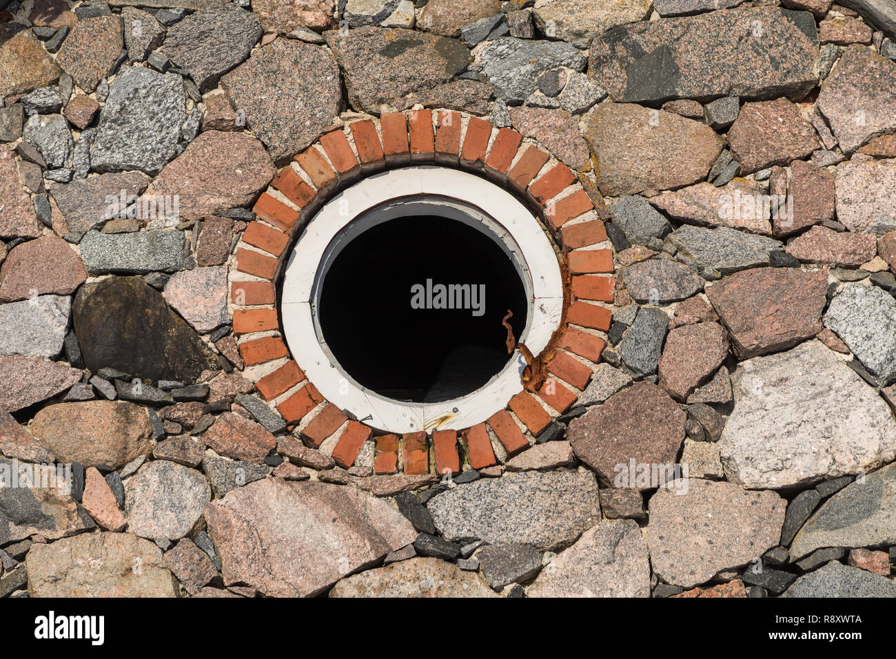 Stone wall texture and windows with red frames, natural background ...