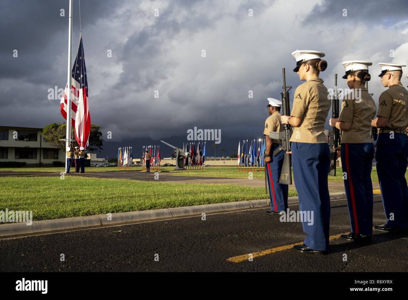 U.S. Marines with the Headquarters Battalion color guard render a rifle ...