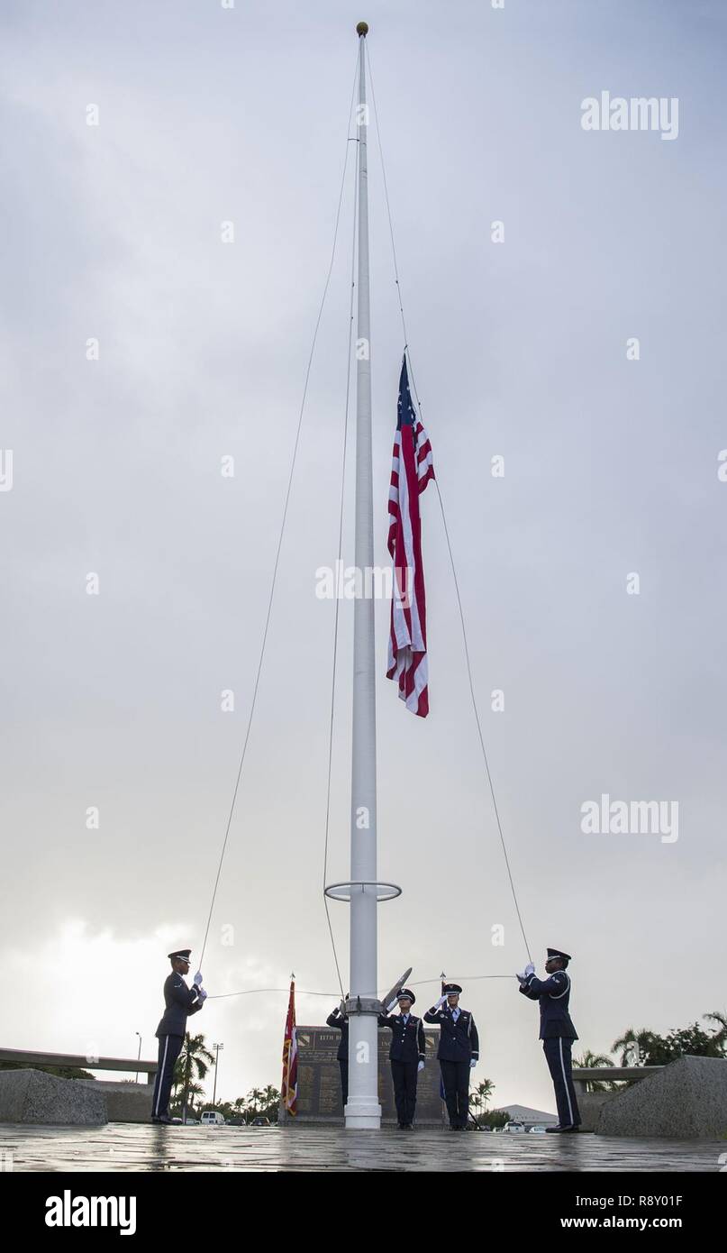 Members of the 15th Wing Honor Guard raise the flag during the Hickam ...