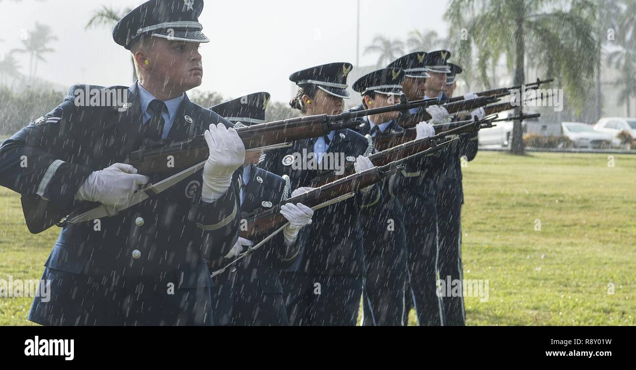 Members of the 15th Wing Honor Guard perform a three volley salute ...