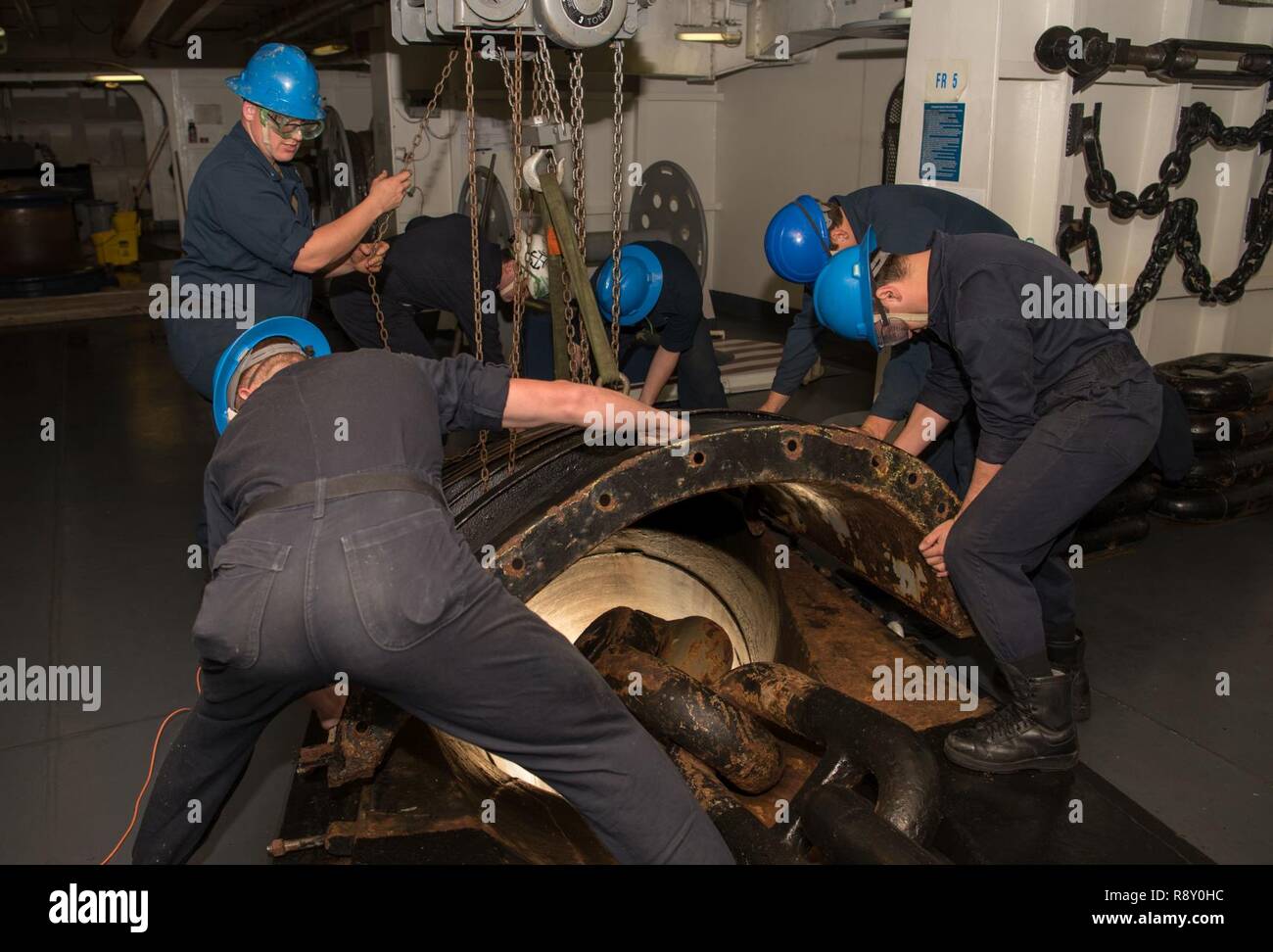 SAN DIEGO (Dec. 7, 2018) Sailors use a chain hoist to lower a hawse ...