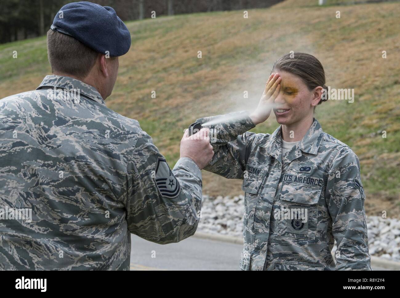 Master Sgt. Chris Kohut sprays Airman 1st Class Kameron Freeman with ...