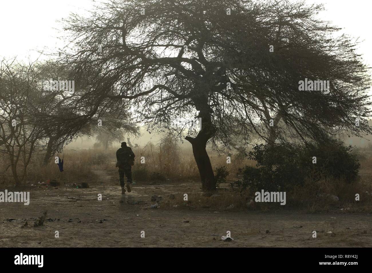 A Niger Army patrol leader moves during small unit tactics training as ...