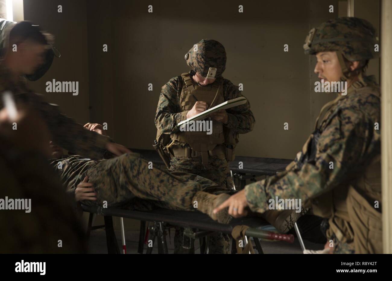 A Navy medical officer with Task Force Southwest writes down a ...