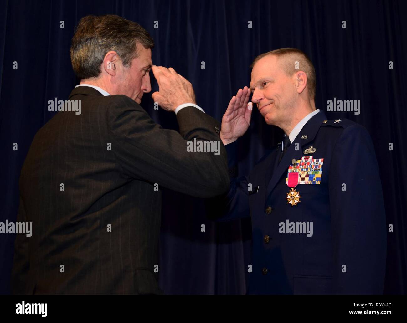 From left, Gov. John Carney salutes Brig. Gen. David Deputy, director ...
