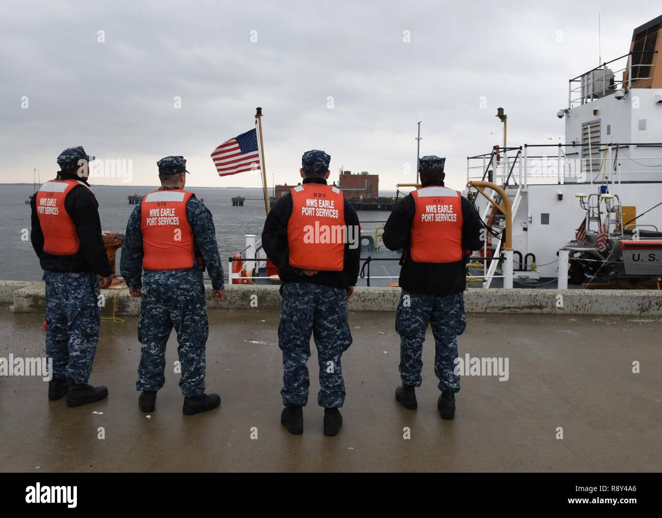 NEW YORK – U.S. Navy members stand ready to help as Coast Guard Cutter ...