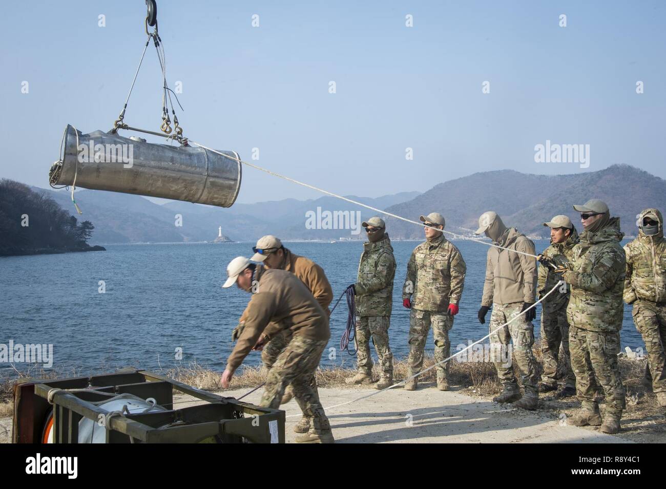 Members of the Republic of Korea (ROK) Navy Underwater Dive Team lift a ...