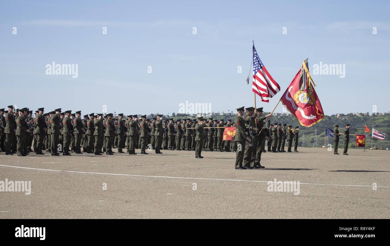 U.S. Marines with the 5th Marine Regiment, 1st Marine Division salute ...