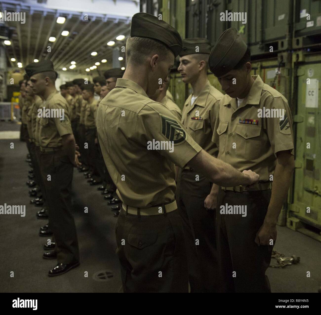 Marines with 3rd Battalion 6th Marine Regiment hold a service uniform ...