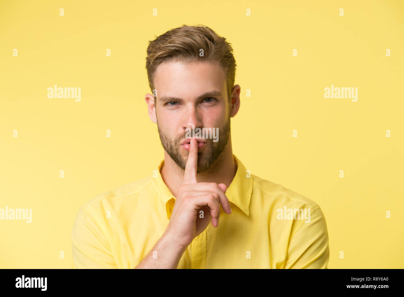 Can you keep secret. Handsome man keep index finger by his lips. Be ...