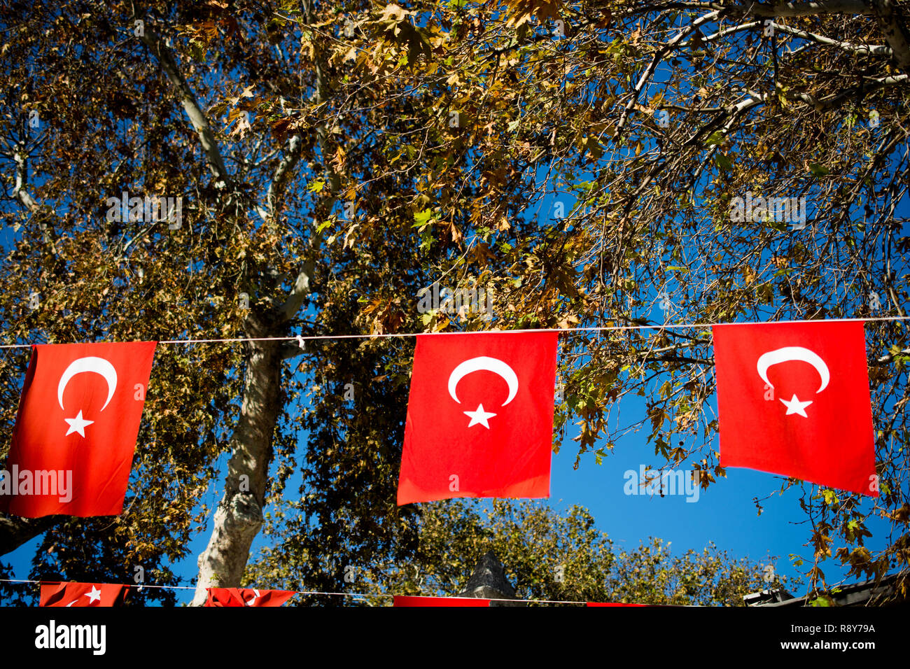 Turkish national flag hang on a pole on a rope in the street in open ...