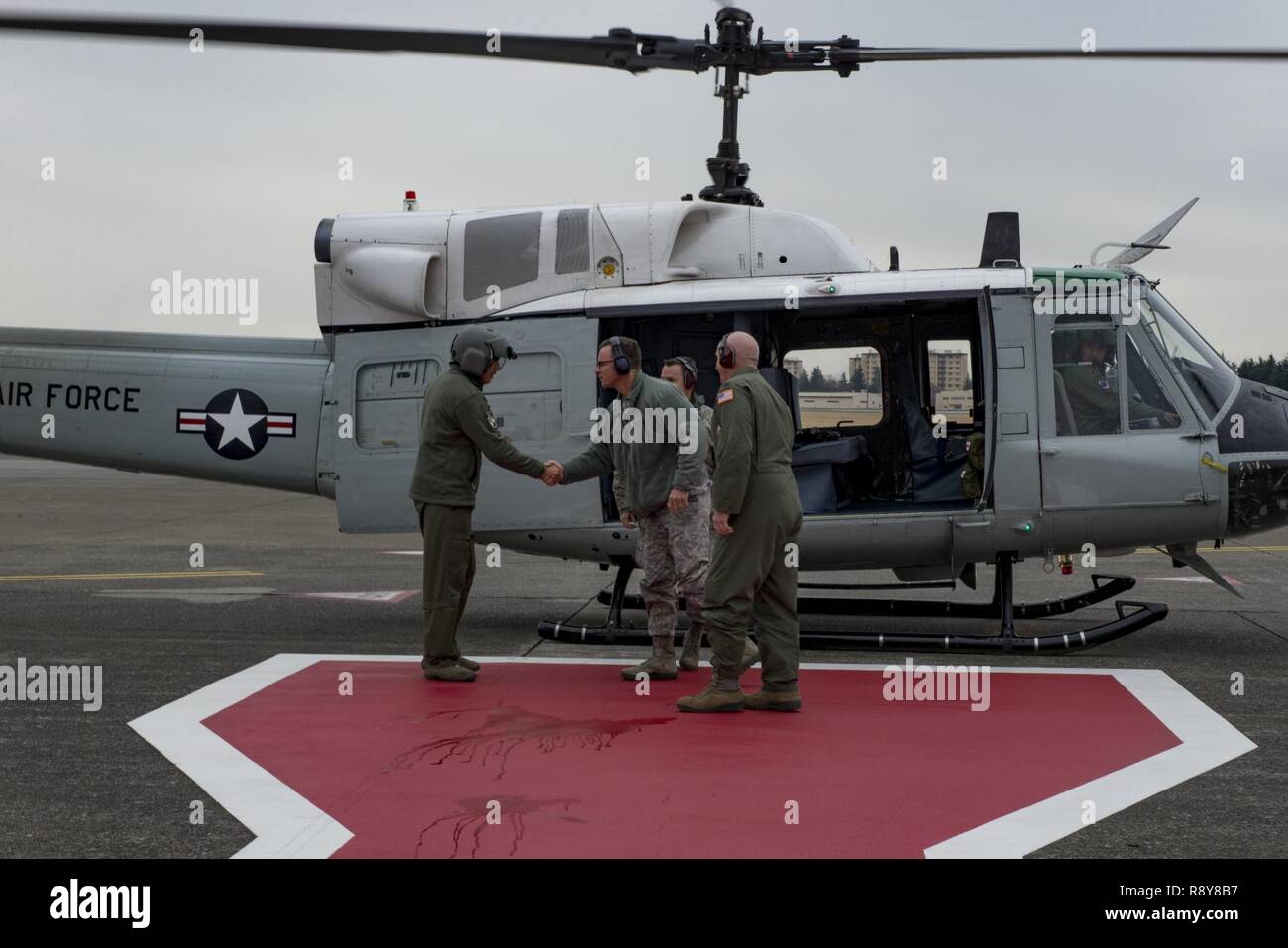Maj. Gen. Mark Dillon, Pacific Air Forces vice commander, shakes hands ...