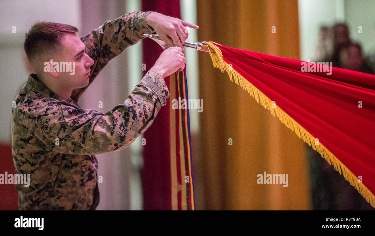 U.S. Marine with 3d Marine Division, 4th Marine Regiment attaches a ...