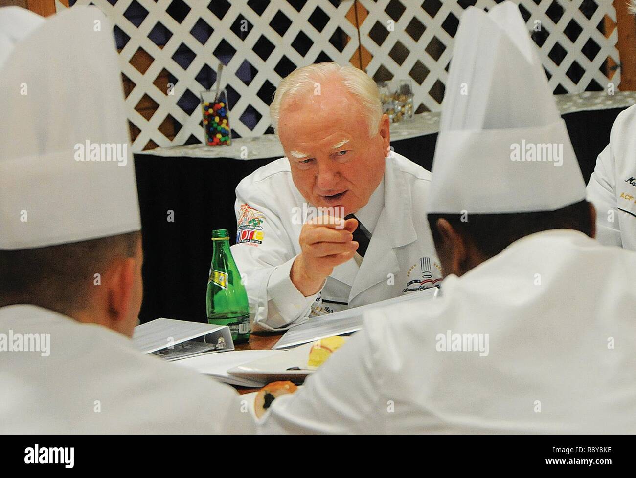 Chef Roland Schaeffer critiques the work of students during a session ...