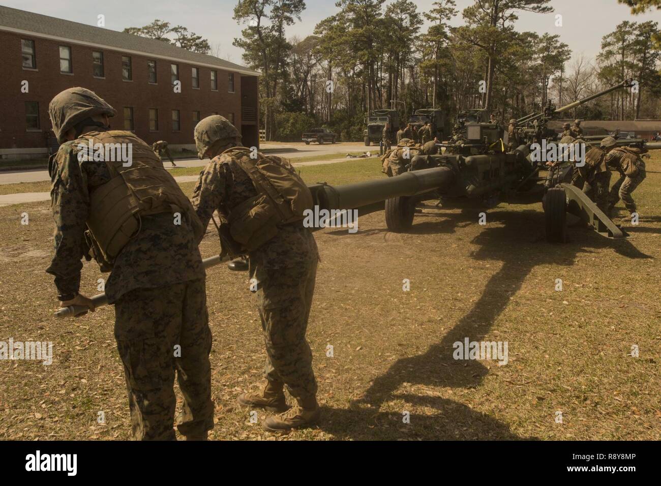 Marines maintain control of the barrel of a M777 howitzer during a ...