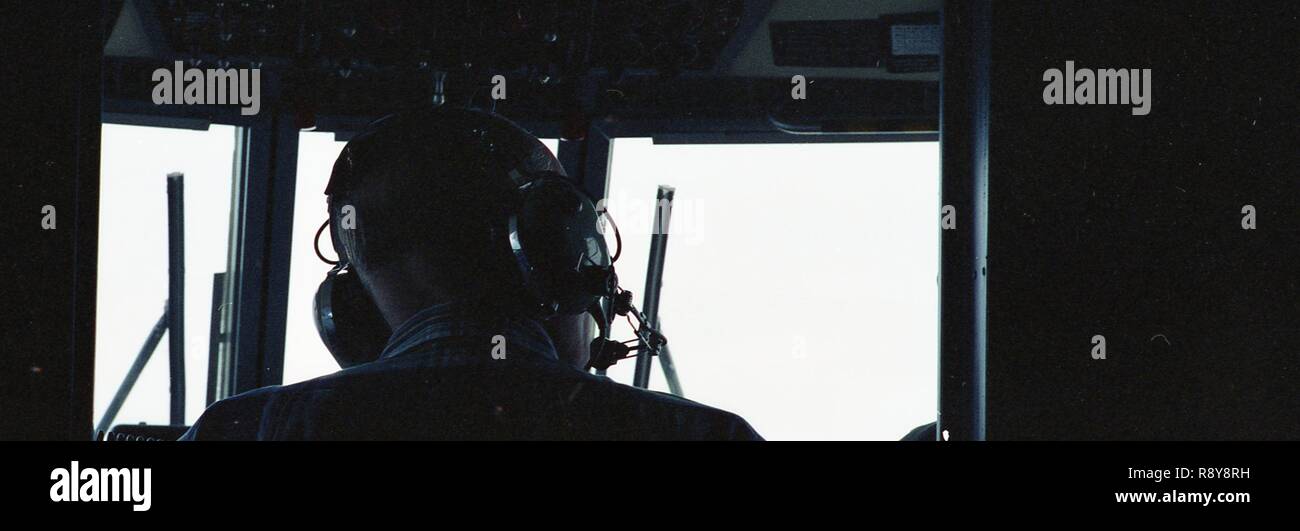 man in plane with headphones on Stock Photo - Alamy