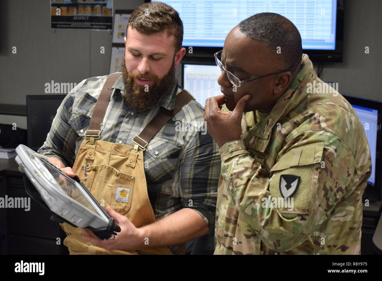 Dustin Cox (left), a material handler, explains how Crane Army's Depot ...