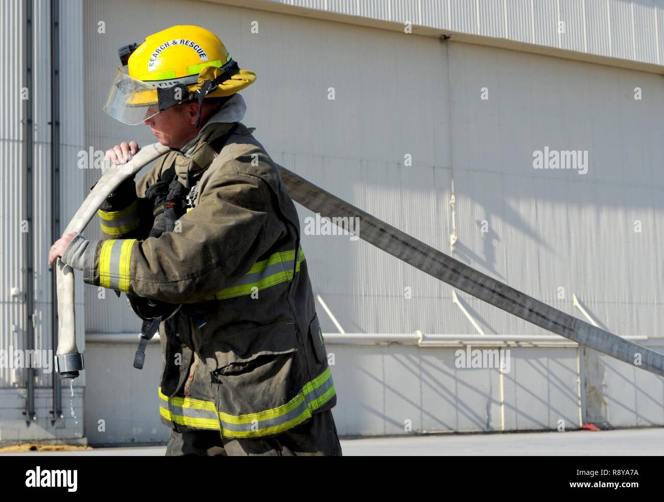 Tim McCartney North Lemmon fire department firefighter, rolls up a fire ...