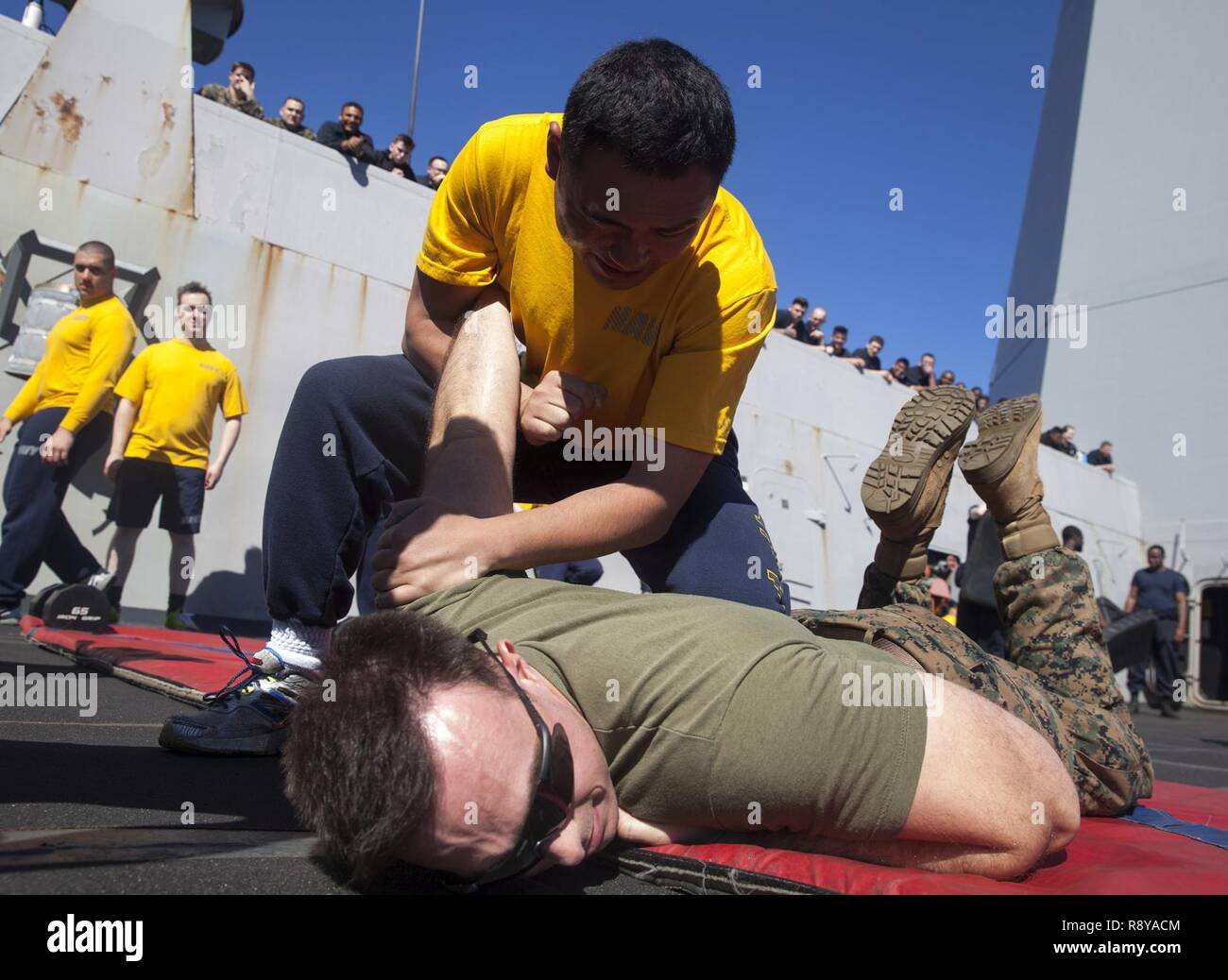 Seaman Henry Ji of USS Mesa Verde (LPD 19) executes an armbar takedown ...