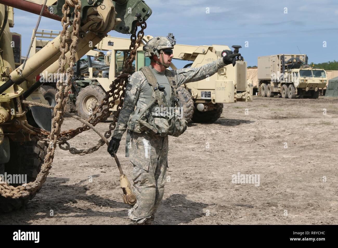 A 710th BSB Soldier prepares to recover a vehicle from a muddy spot ...