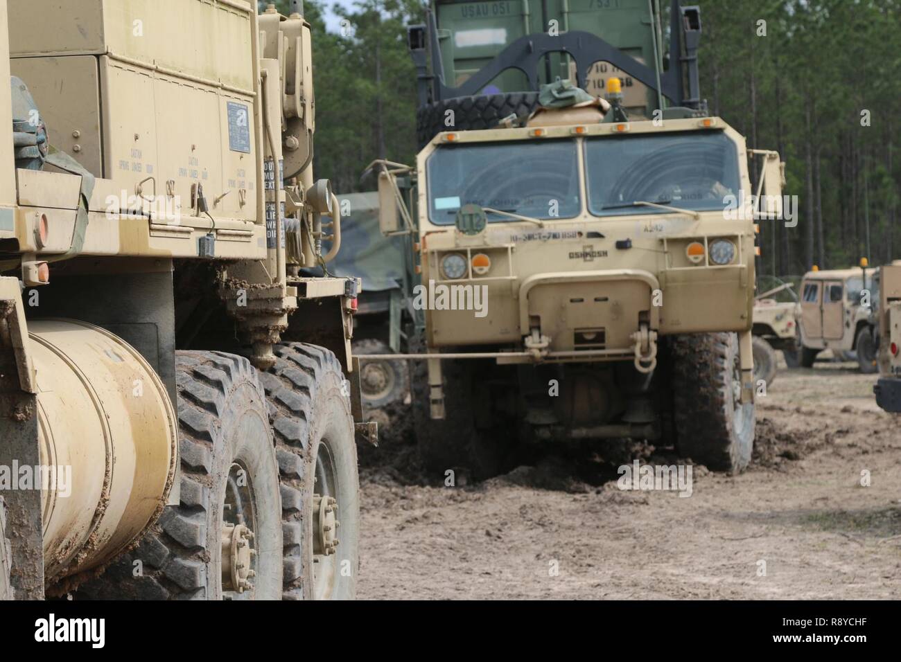 A military vehicle is pulled from the mud via a wench system during the ...