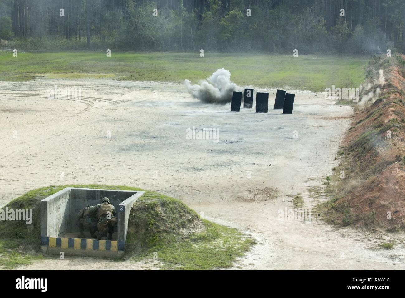 An M67 fragmentation grenade explodes during a live-fire grenade range ...