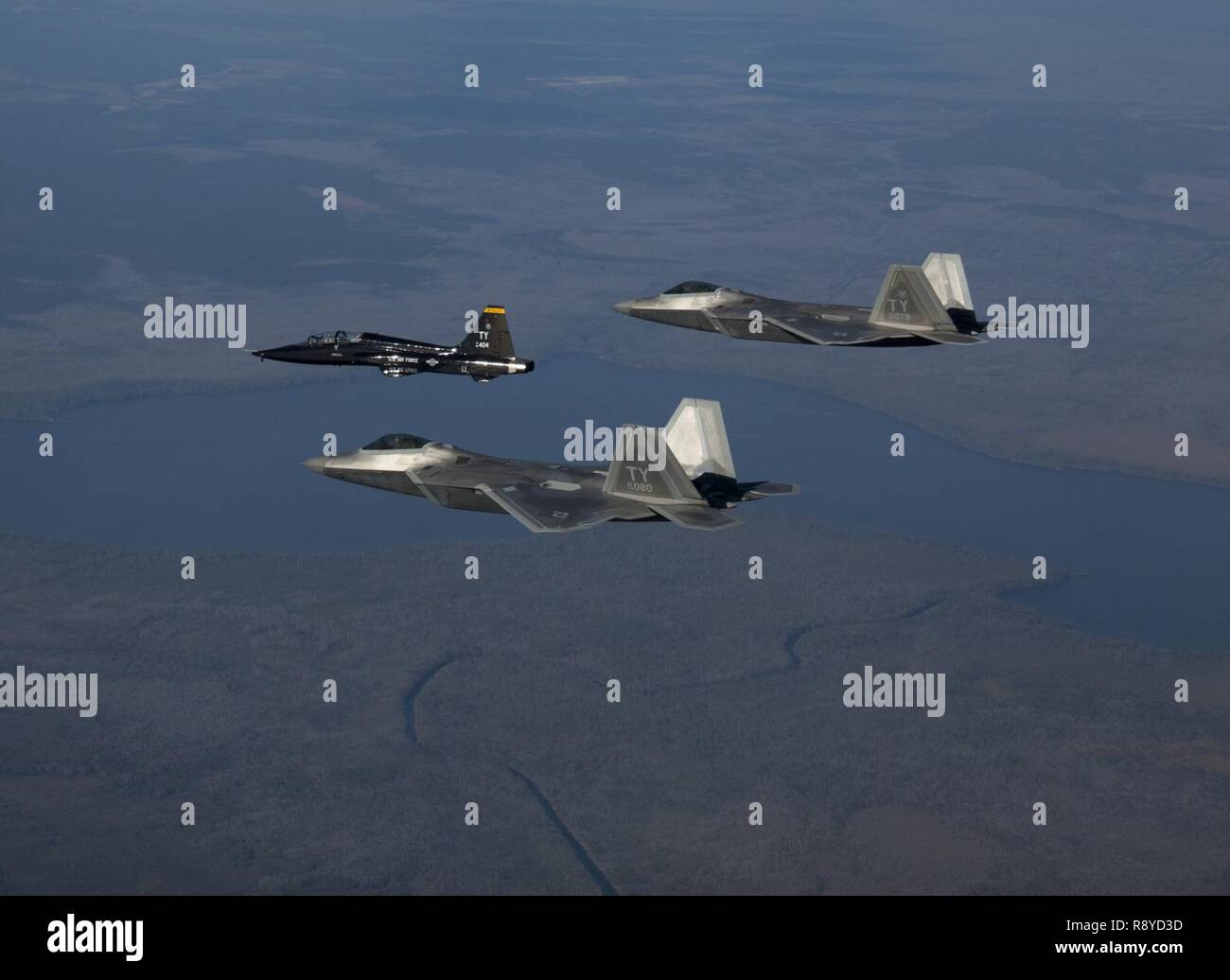 A pair of F-22 Raptors with the 95th Fighter Squadron and a T-38 Talon ...