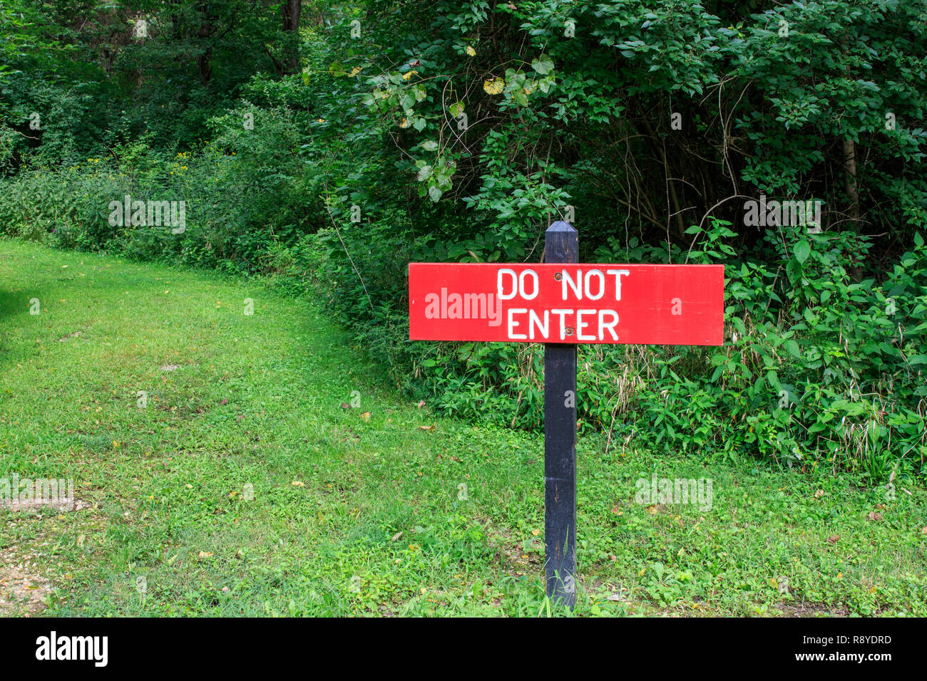 Do not enter sign along a forest path Stock Photo - Alamy