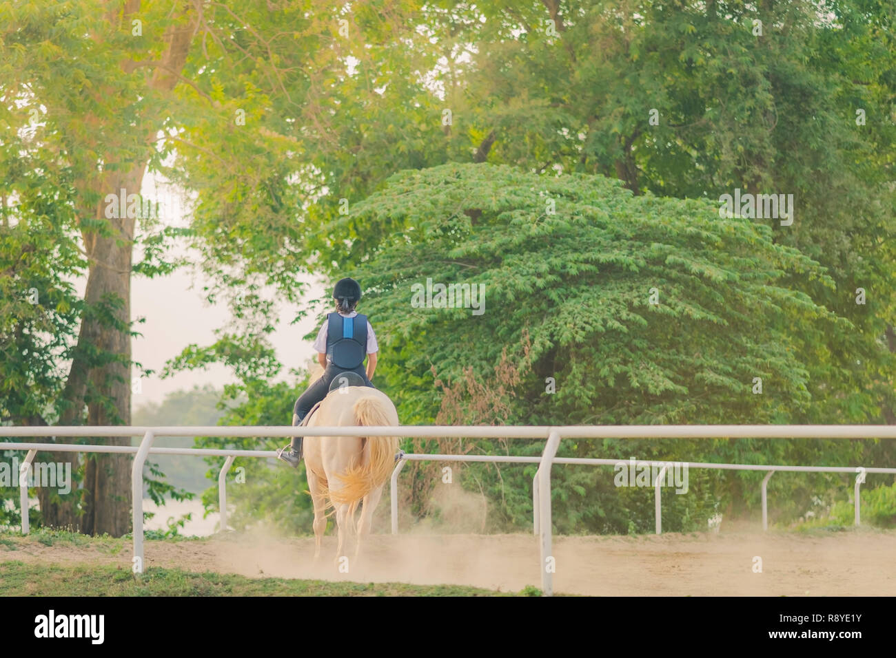 Asian child riding horse helmet hi-res stock photography and images - Alamy