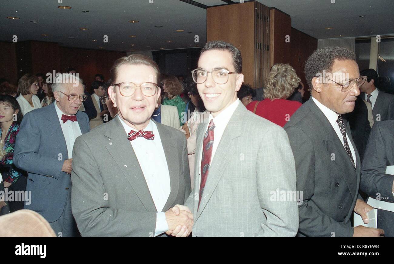TWO MEN TAKING A PICTURE - SHAKING EACH OTHER HANDS Stock Photo - Alamy