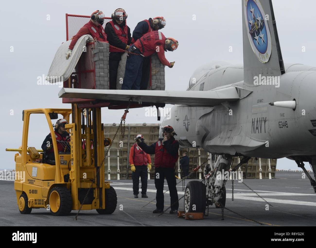 PACIFIC OCEAN (March 15, 2017) Sailors are lifted on top of a dummy jet ...