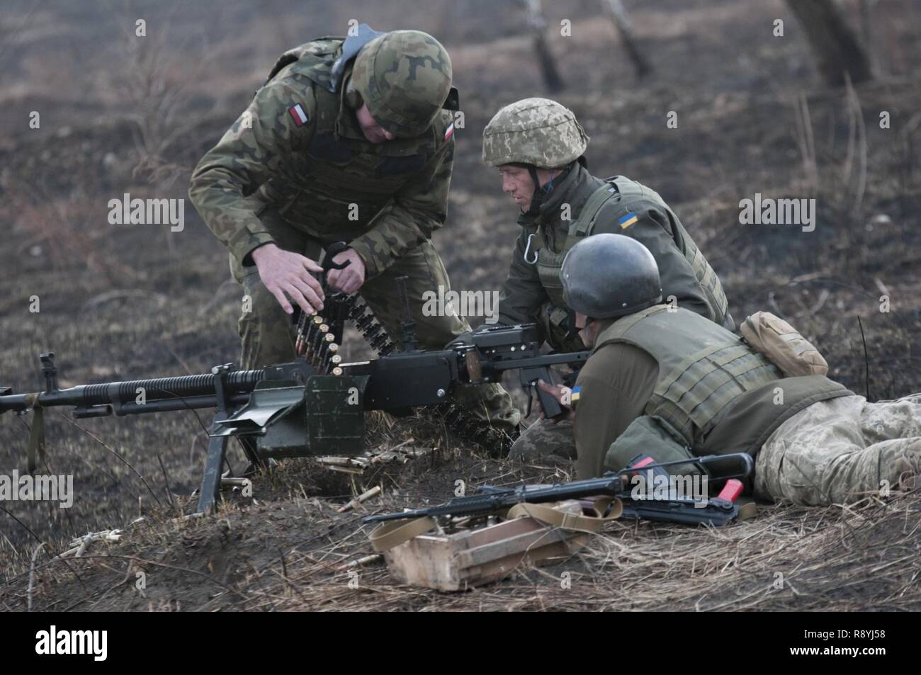 A Polish army instructor provides feedback to Ukrainian soldiers of the ...