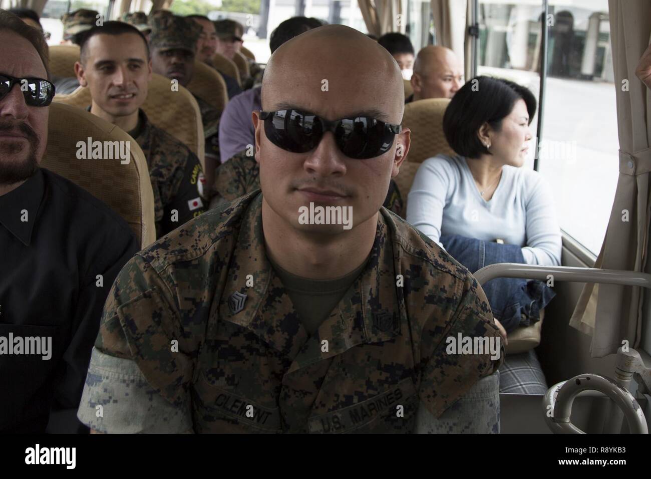 CAMP NAHA, OKINAWA, Japan – Staff Sgt. Anthony Clement sits on a bus ...