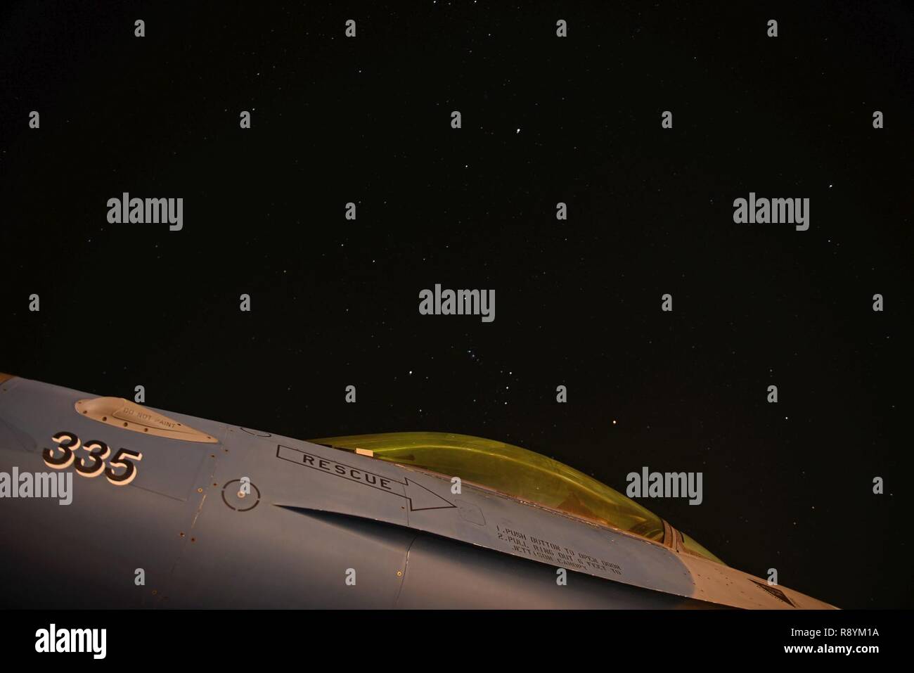 A U.S. Air Force F-16 Fighting Falcon sits under the night sky at Royal ...