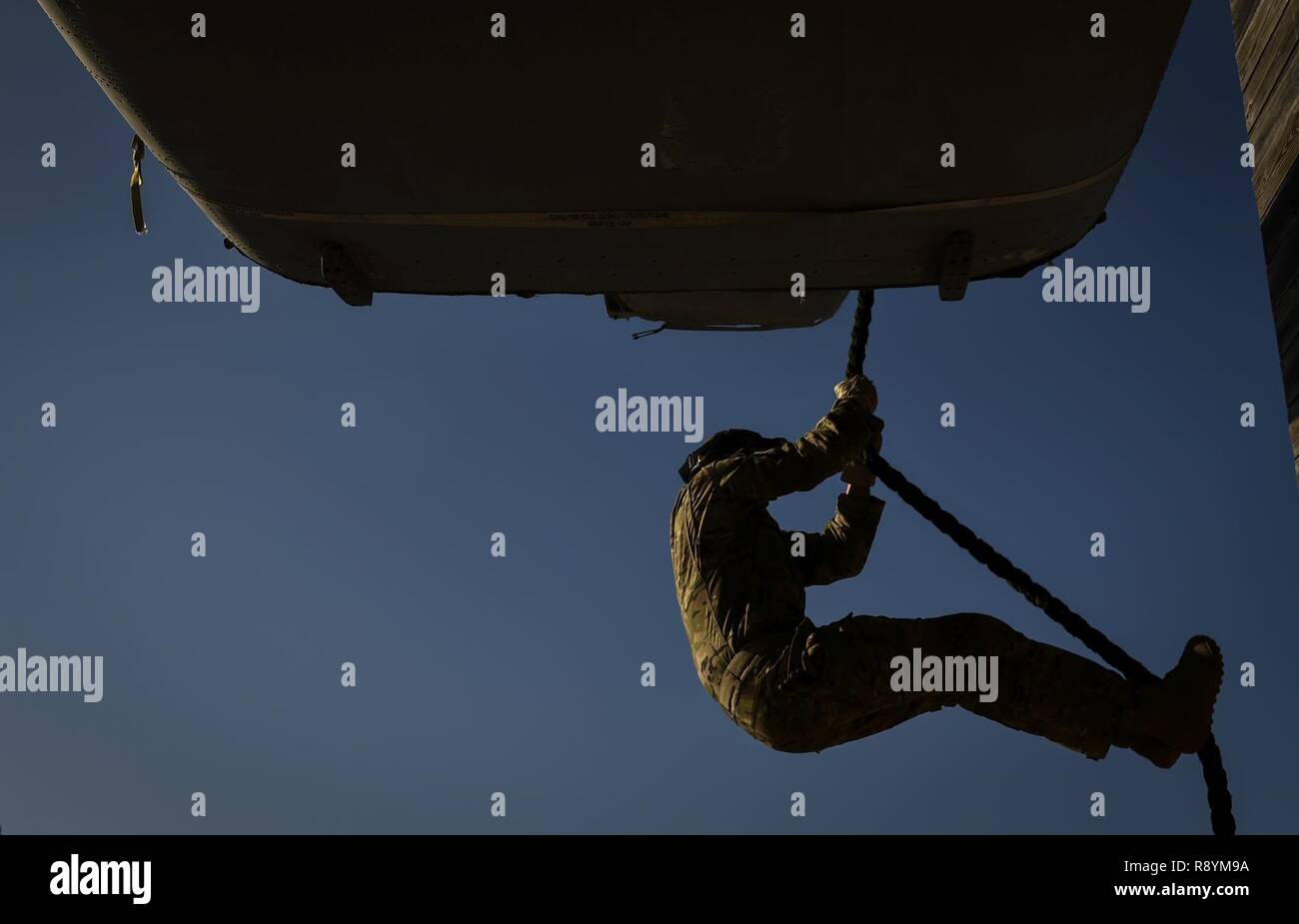 A Soldier with the 1st Battalion, 10th Special Forces Group, fast ropes ...