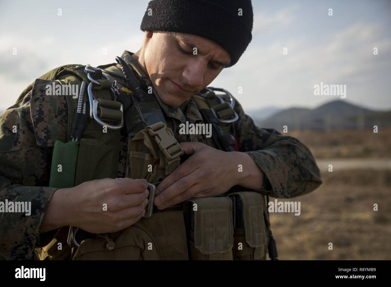 Cpl. Dominic Lopez straps into his parachute at Josari drop zone ...