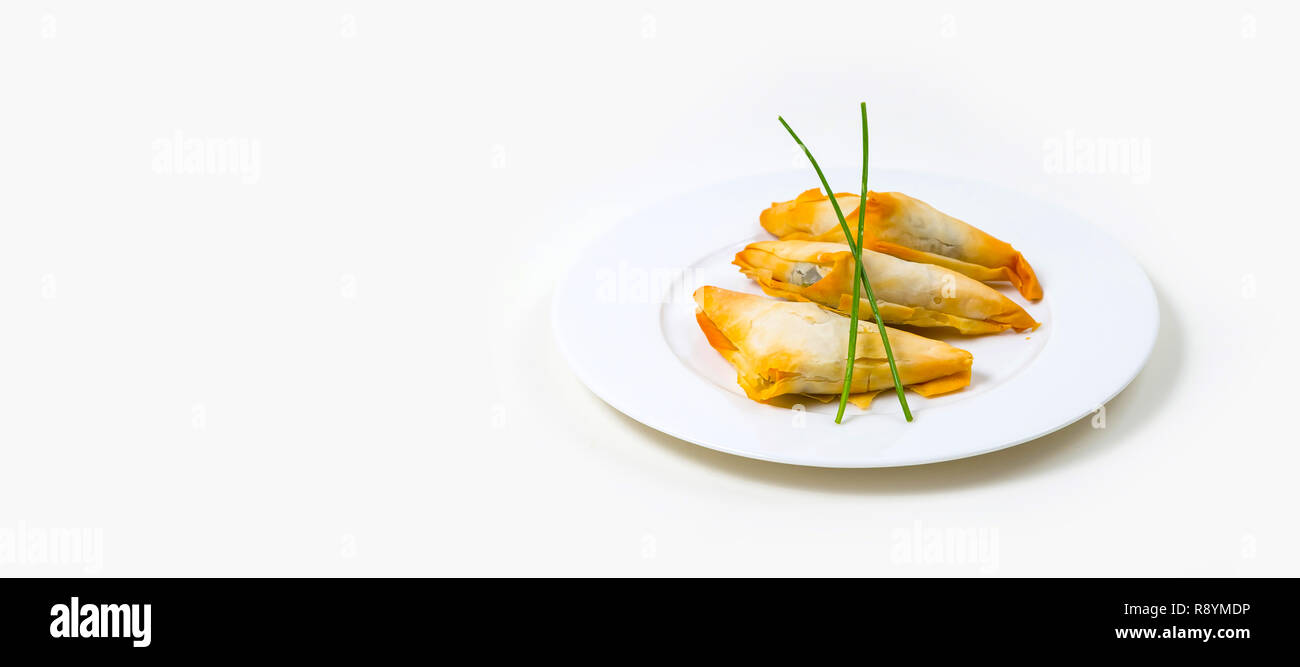 Samosa on a white plate on a white background isolated Stock Photo - Alamy