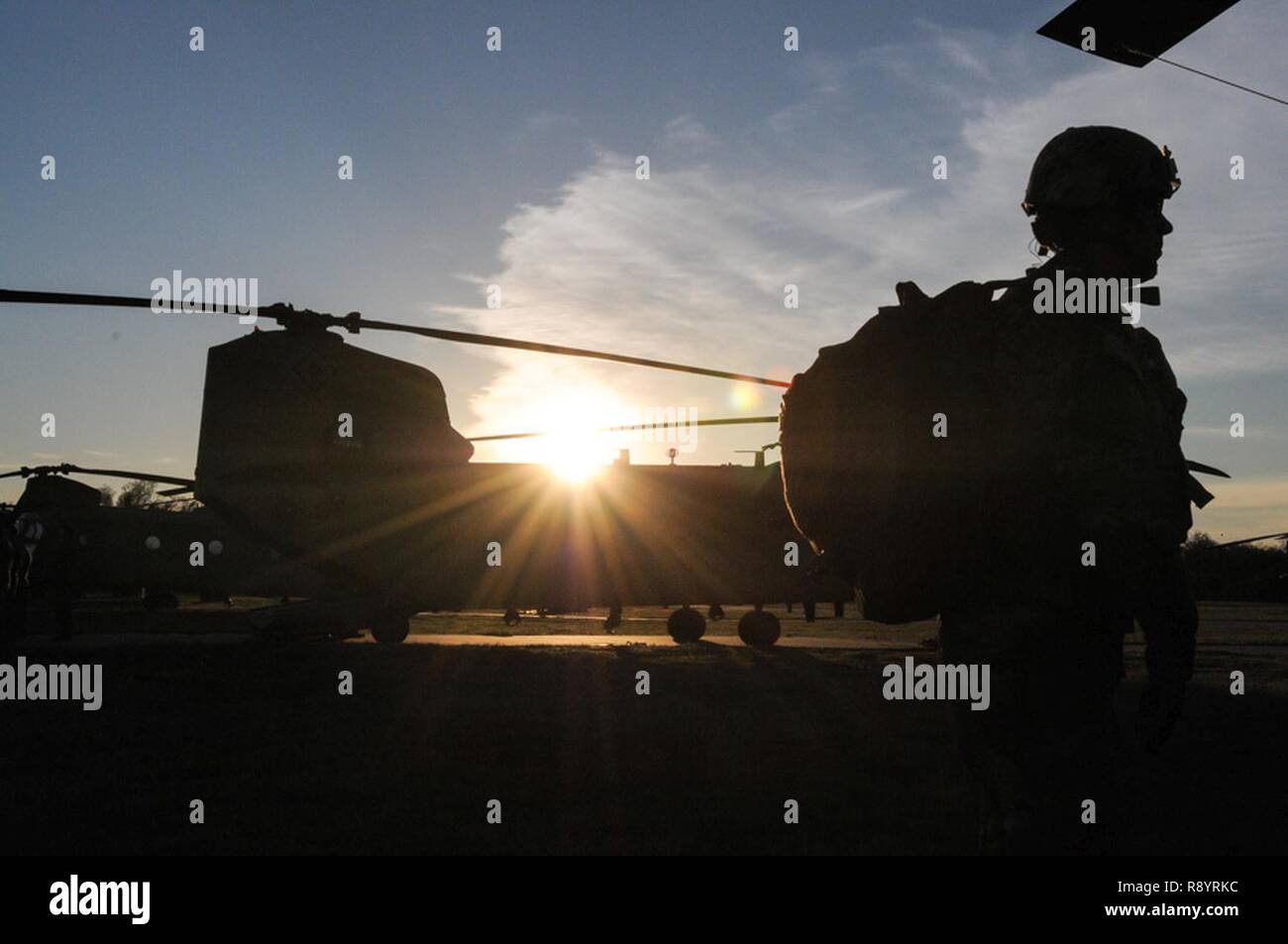 A Soldier from the 29th Combat Aviation Brigade stands in front of a CH ...