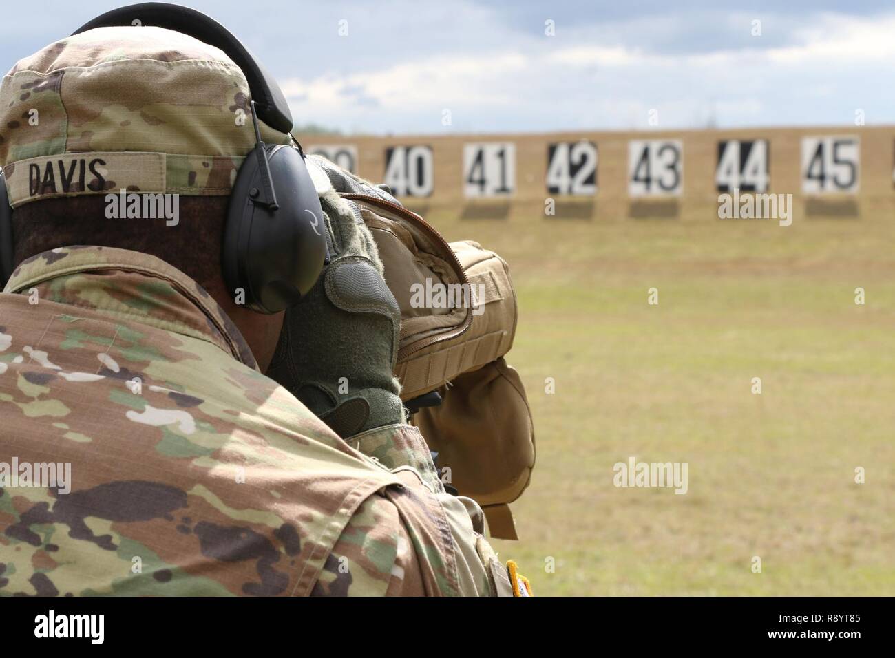 A Soldier verifies the accuracy of his teammate’s shots during a rifle ...
