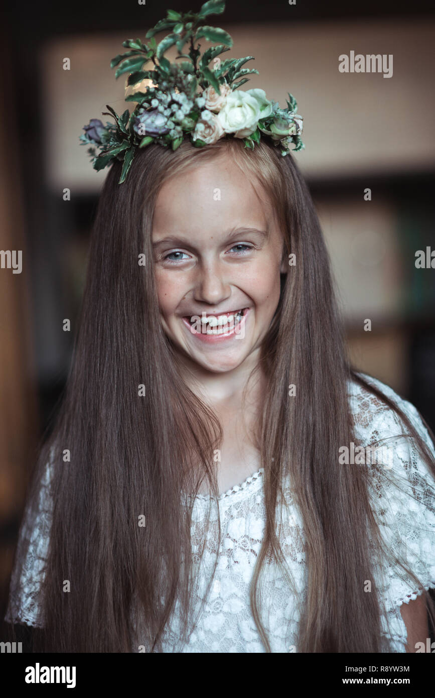 cute girl with very long hair and a beautiful wreath of flowers on her ...