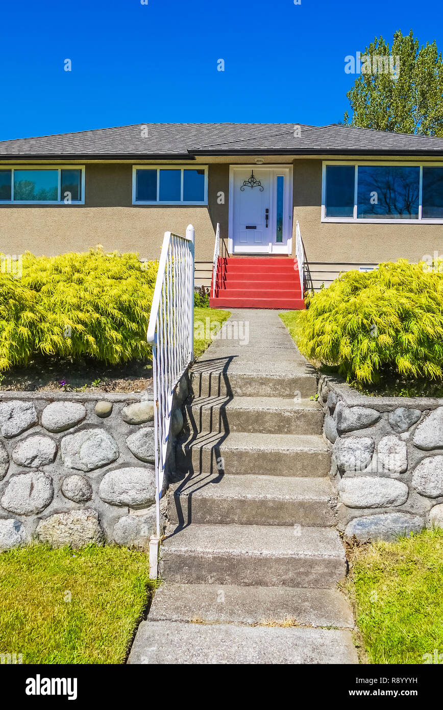 Entrance of modest residential house. Family house with front yard ...