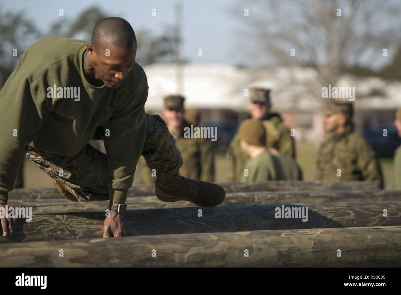 A Marine clears an obstacle during the obstacle course portion of the ...
