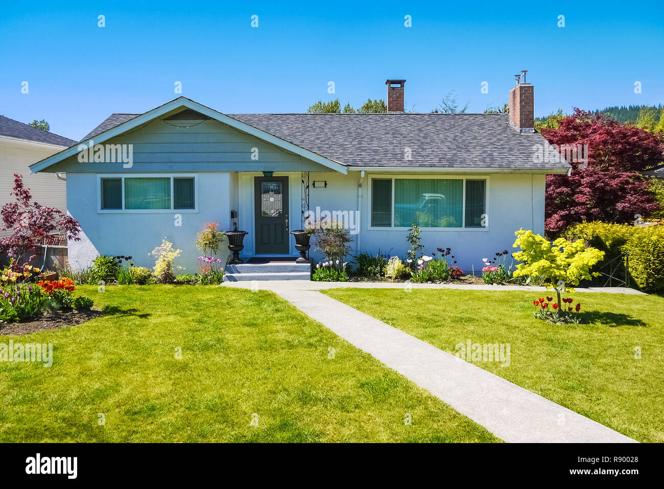 Average family house with concrete pathway over front yard. Residential ...